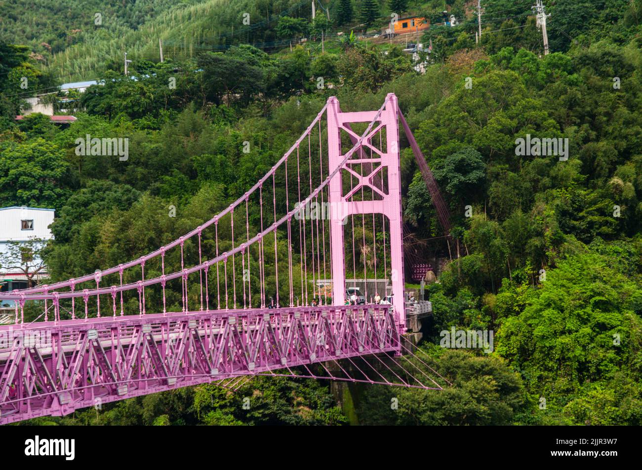 A scenic view of the Luofu Bridge above a river surrounded by green ...