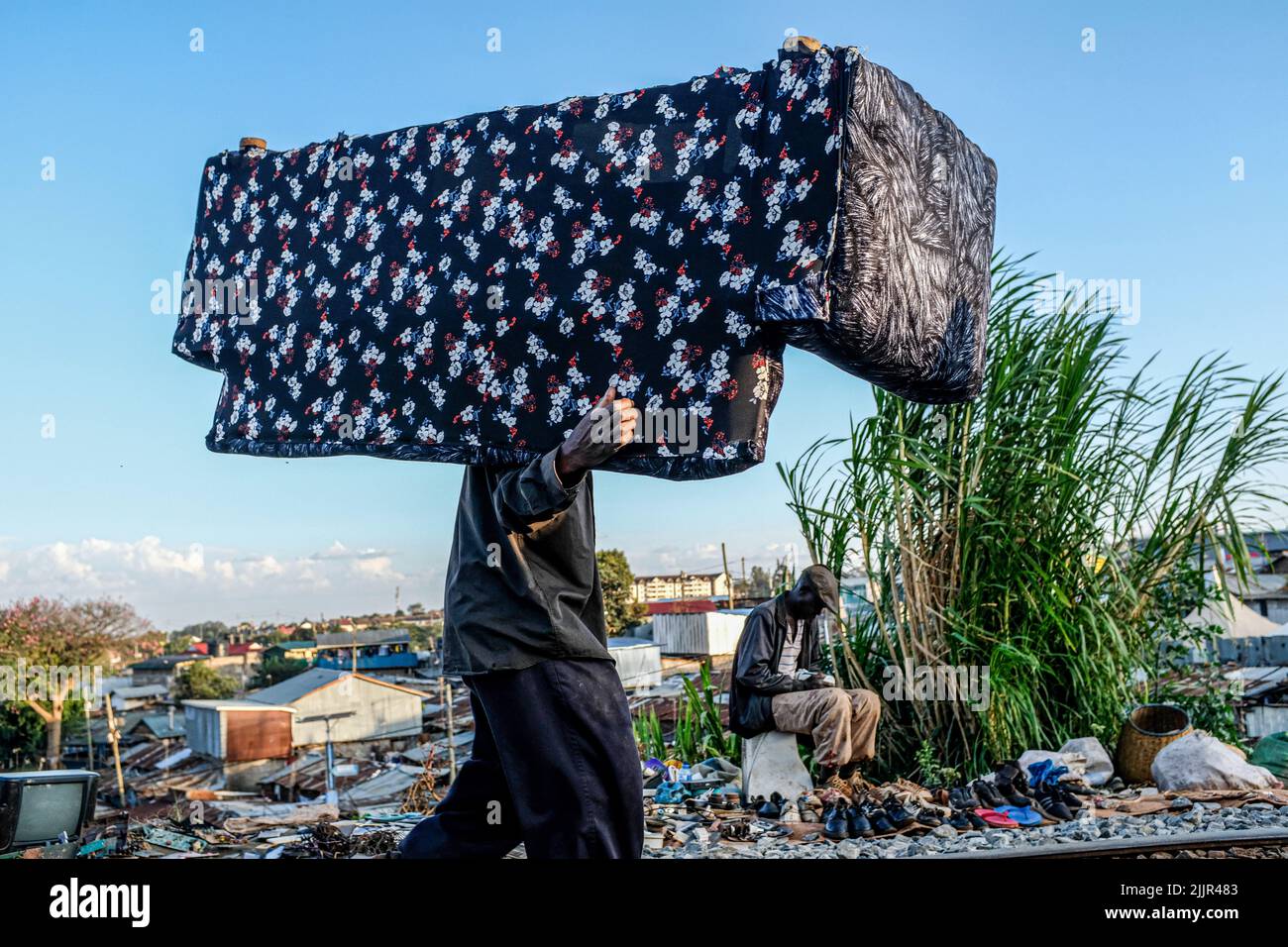 Nairobi, Kenya. 29th Mar, 2022. A man carrying a sofa along the streets ...