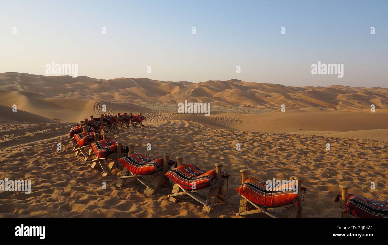 Traditional bedouin seating is set up in the middle of the desert ...