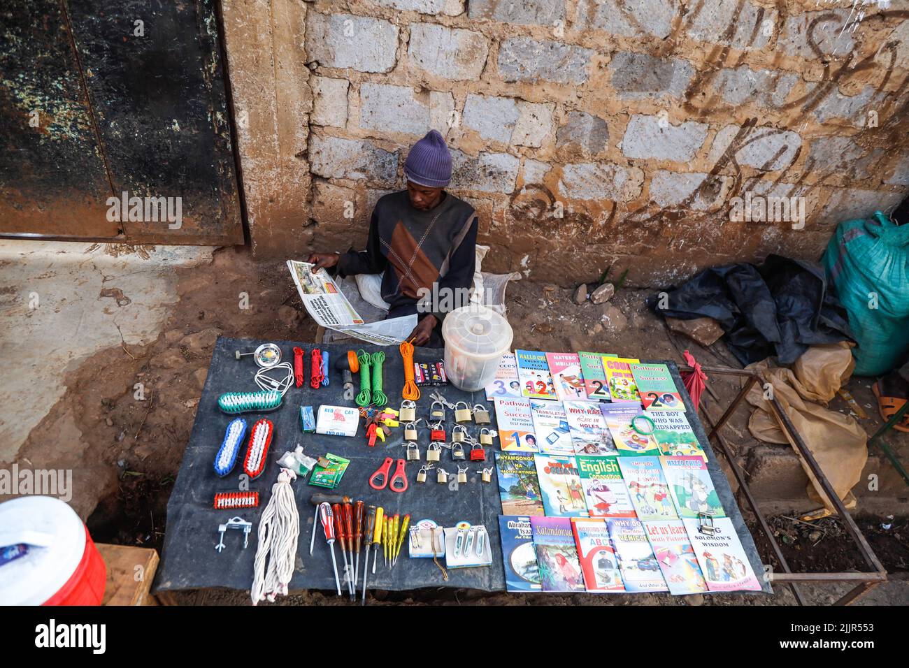 Nairobi, Kenya. 16th Mar, 2022. A street vendor reading a newspaper ...