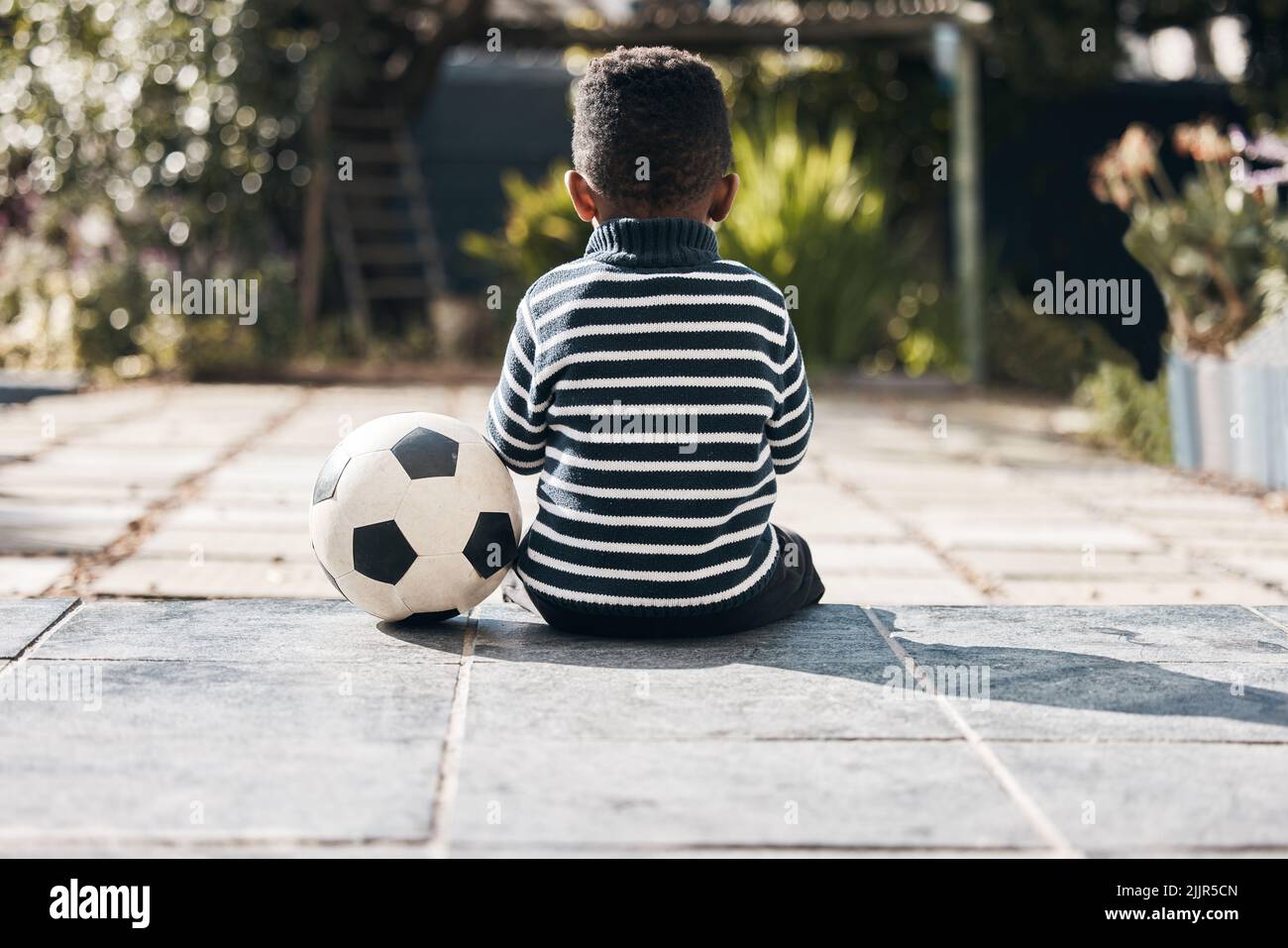 I have no one to play with. an adorable little boy sitting outside with ...