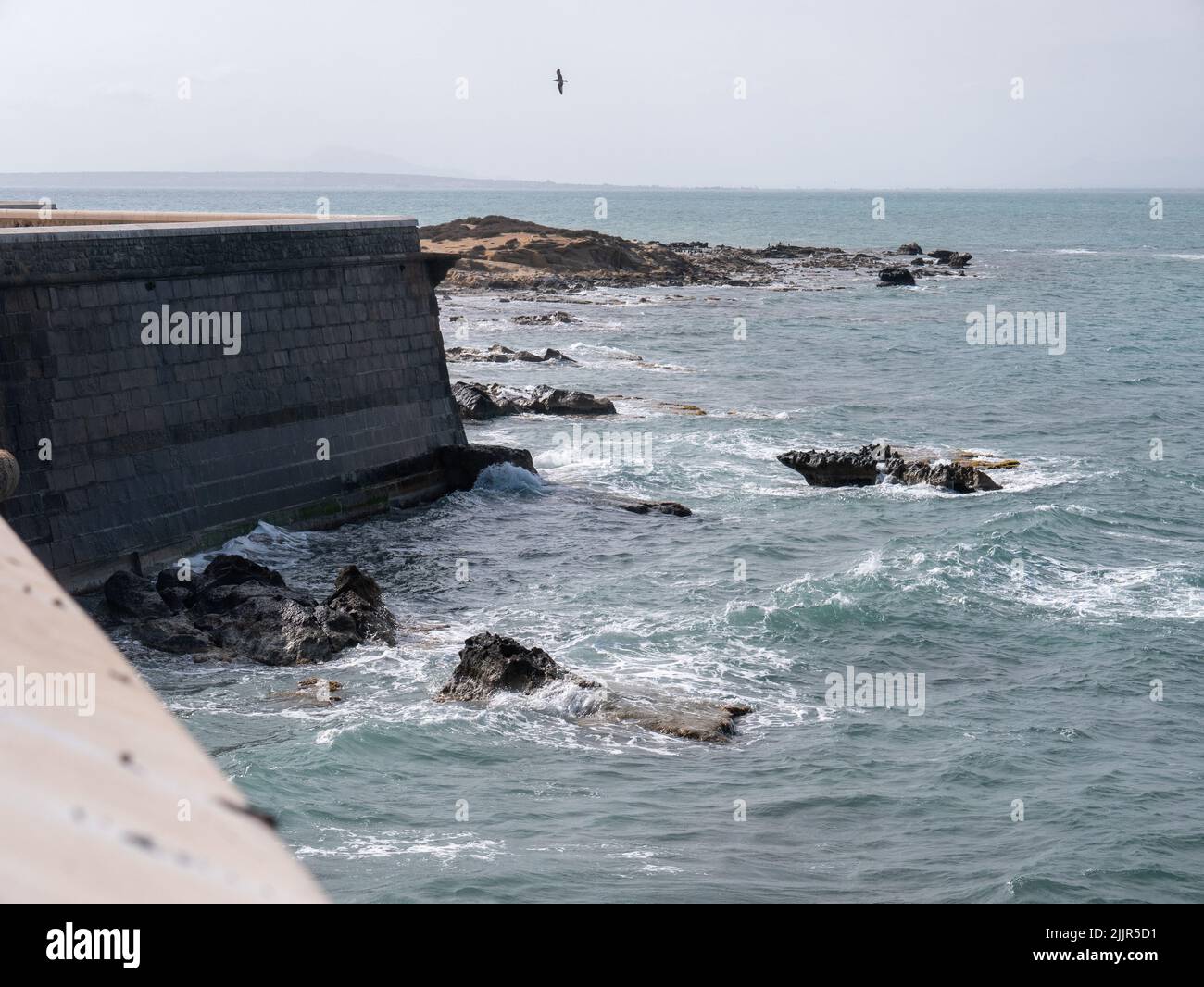 The waves crashing on the rocky shore of Tabarca Island, Alicante ...