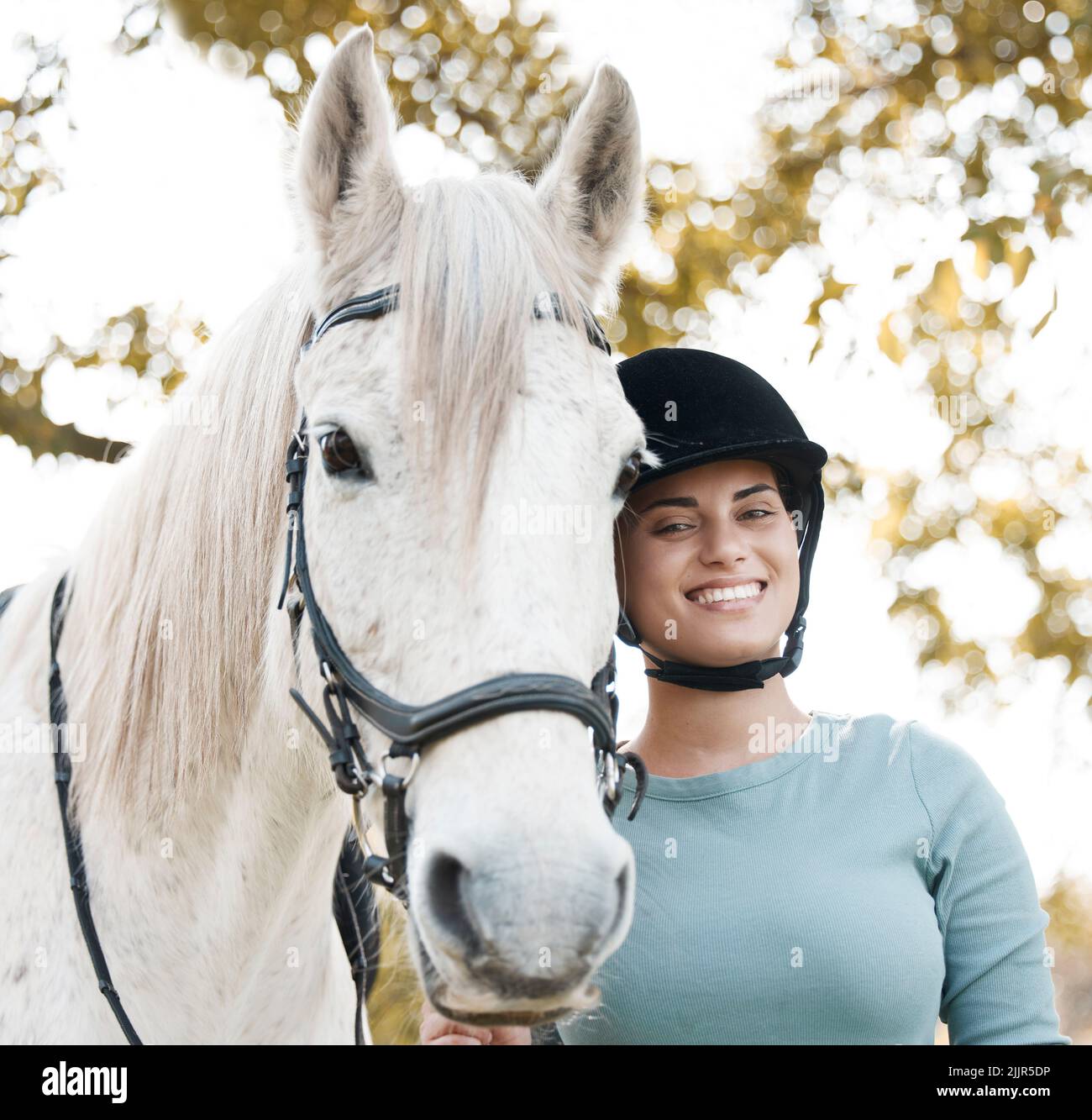 A horse gallops with his heart. an attractive young woman standing with ...