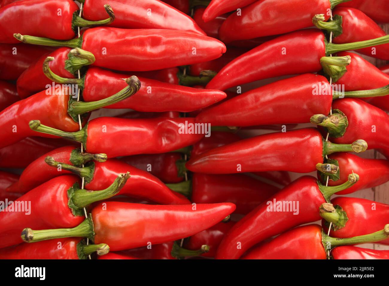 Hanging red peppers on sale in the market of Espelette, France Stock ...