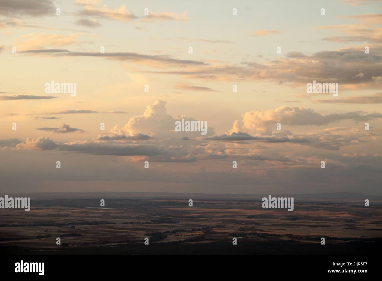 An aerial view of a beautiful sunset in the cloudy sky in a rural area ...