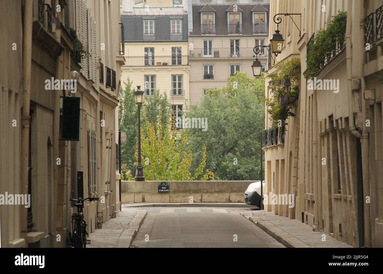 A scenic view of a small alley between two old residential buildings in ...