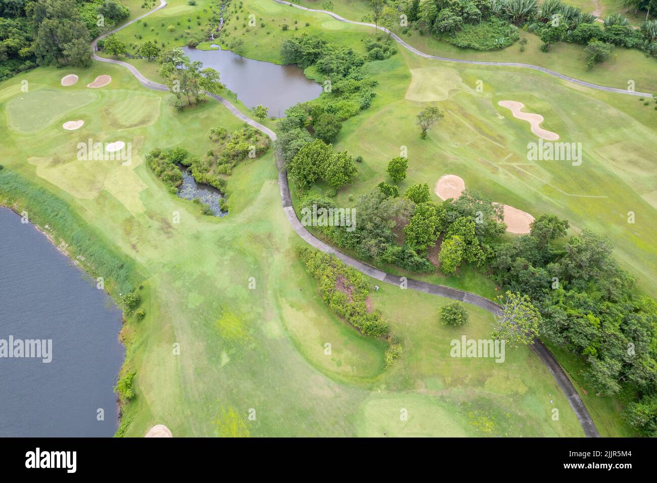 Aerial view drone shot of beautiful green golf field fairway and ...