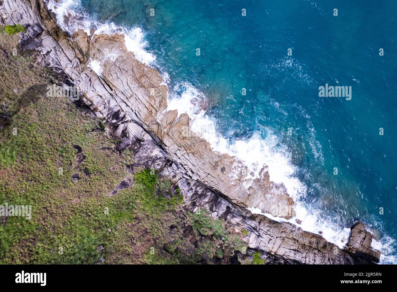 Aerial view of sea crashing waves White foaming waves on seashore rocks ...