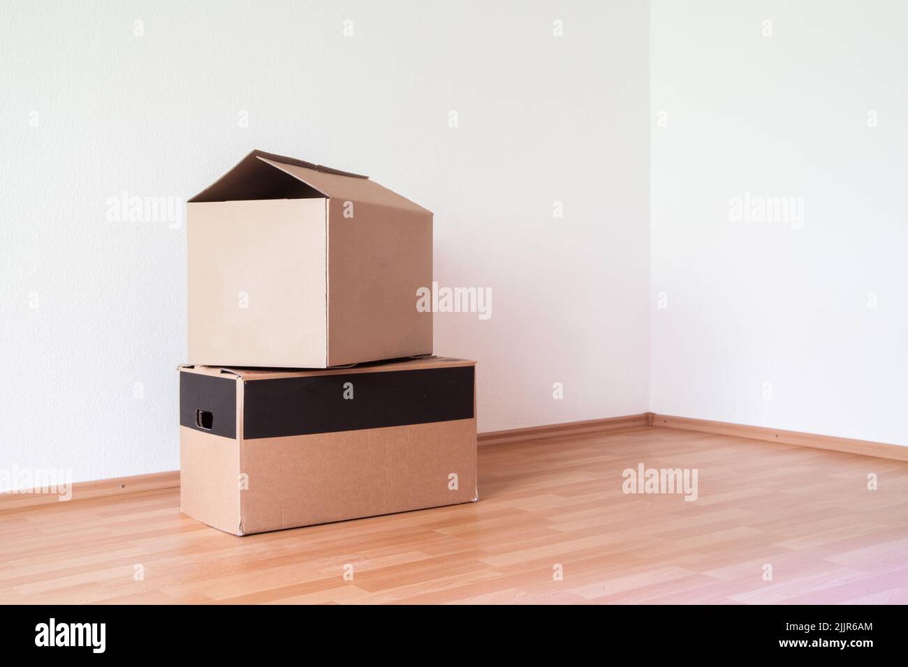 The two small cardboard boxes in the empty room Stock Photo - Alamy