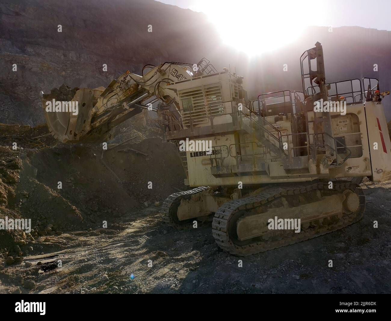 An excavator digging a mine at sunset in Majdanpek, Serbia Stock Photo ...