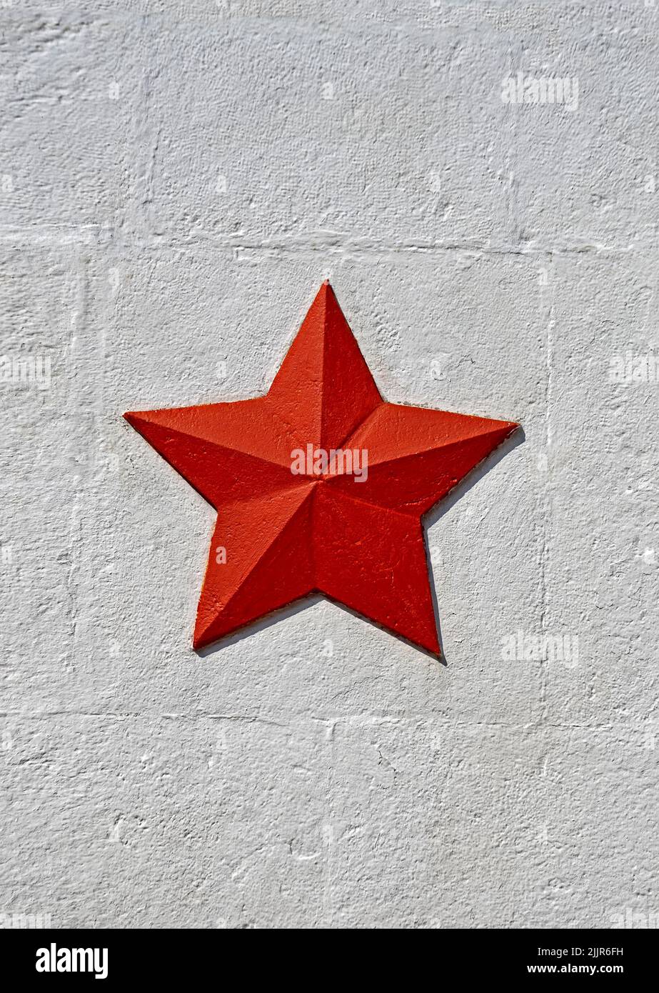 vintage red star on white stone surface closeup, history glory ...