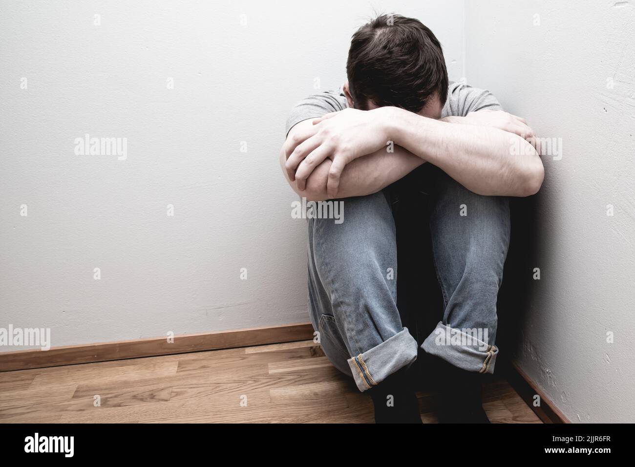 Man Cowering In Corner