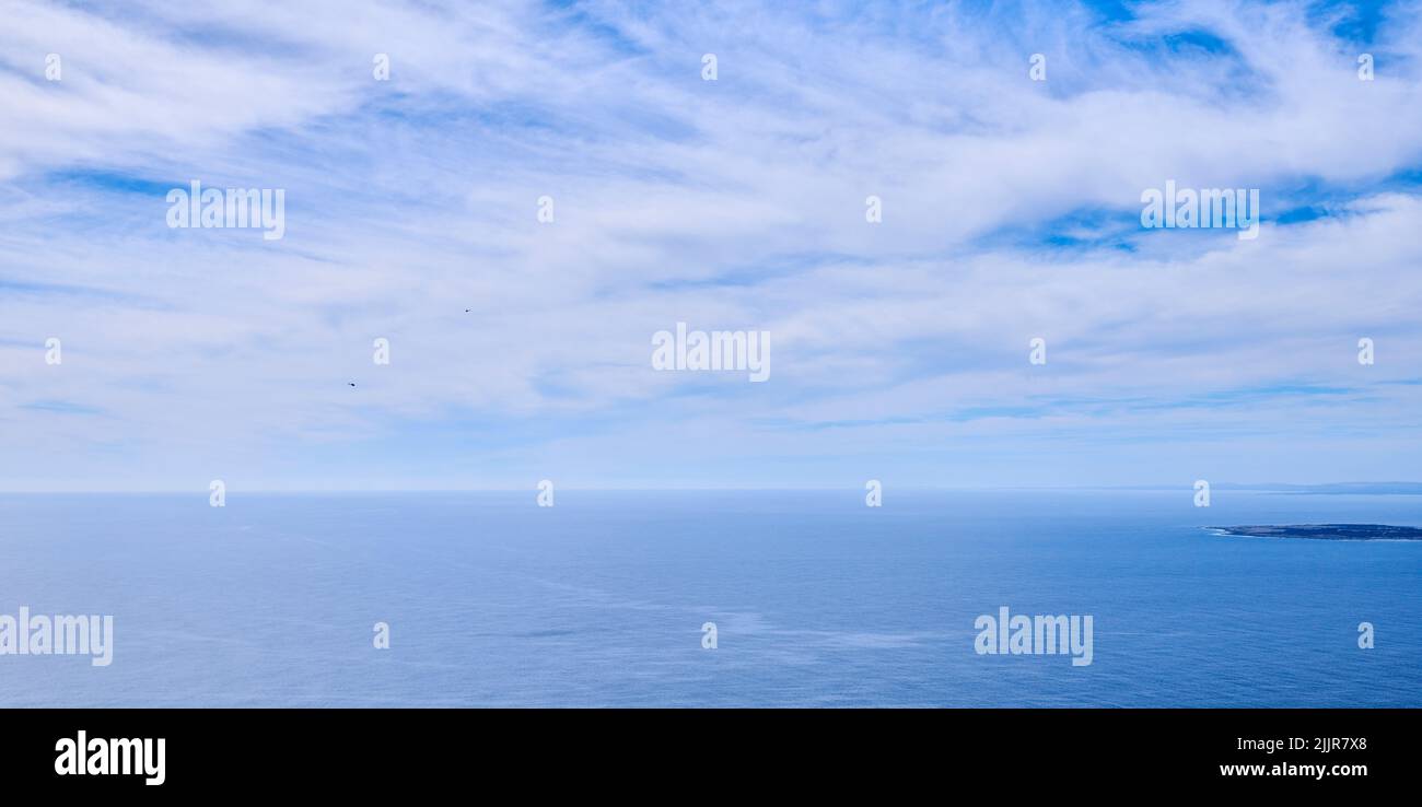 Beautiful, calm and quiet view of the ocean and clouds in blue sky with ...