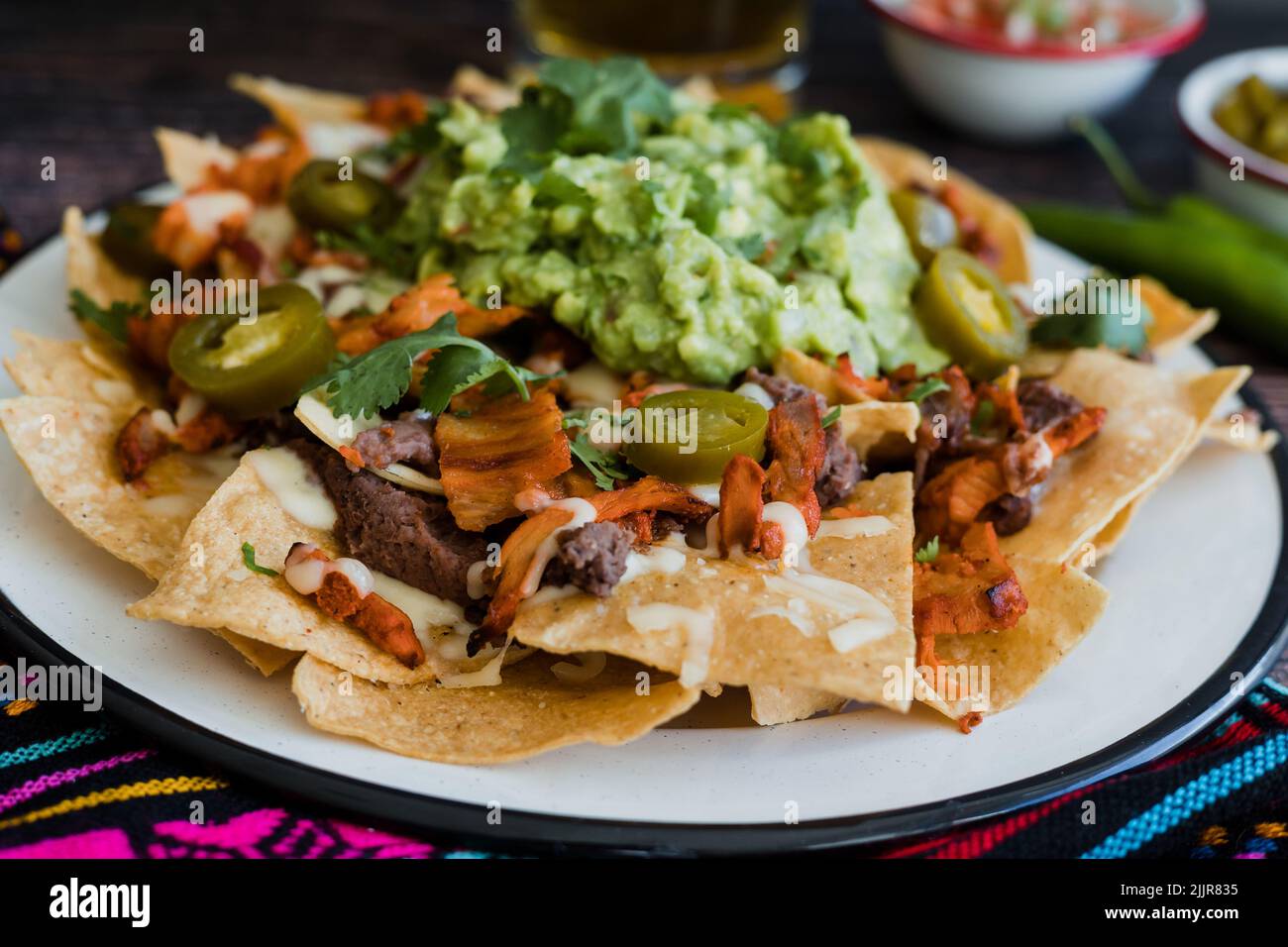 Mexican nachos chips with american cheese and avocado, traditional food ...