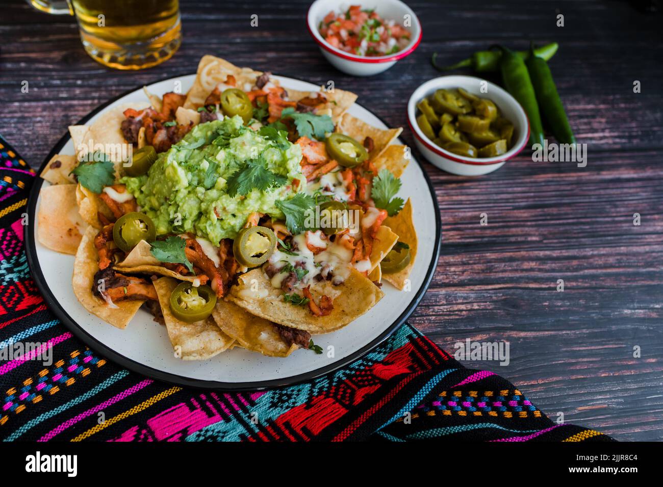 Mexican nachos chips with american cheese and avocado, traditional food ...