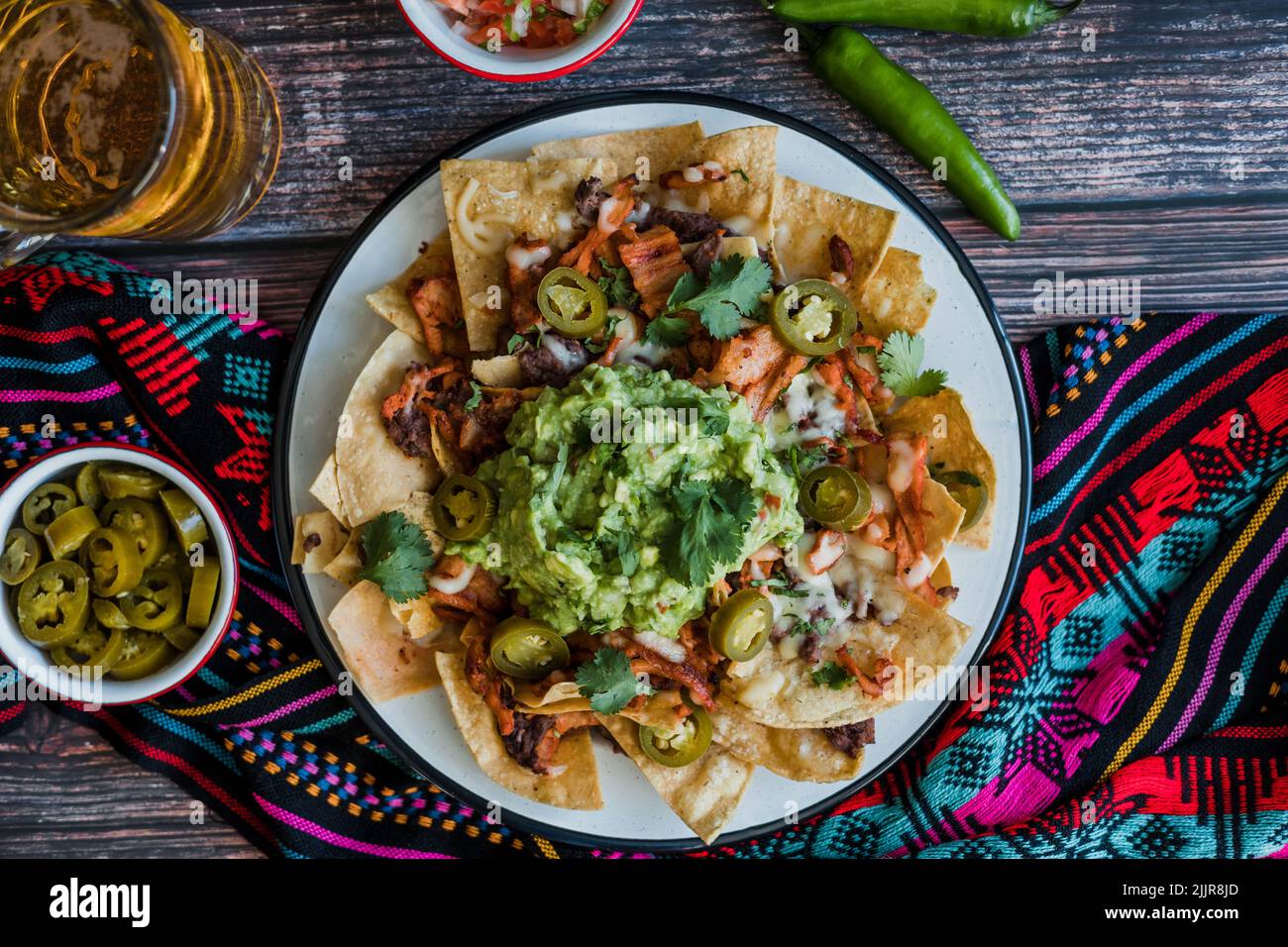 Mexican nachos chips with american cheese and avocado, traditional food ...