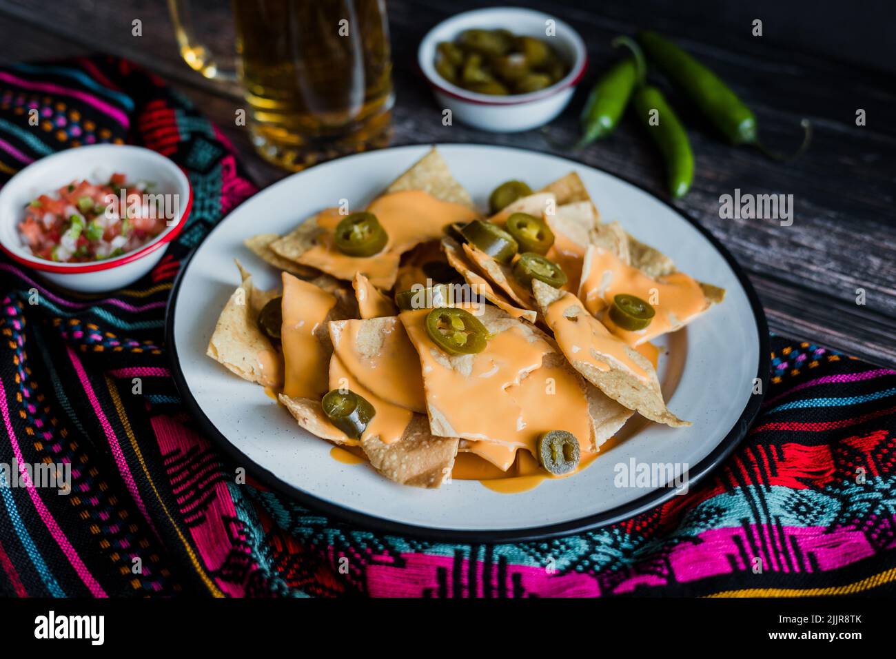 Mexican nachos chips with american cheese, beer and jalapeños in Mexico ...