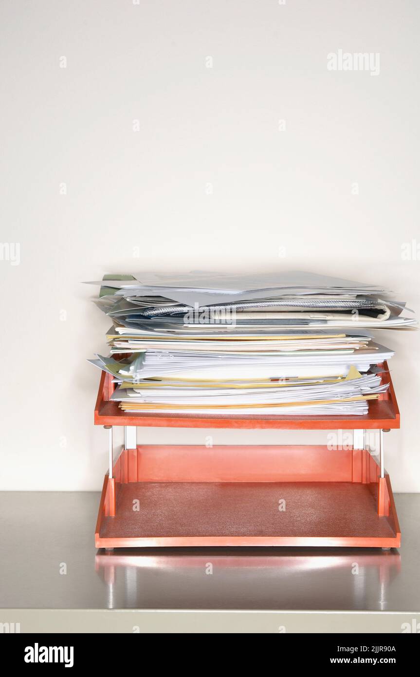 A vertical shot of a stack of documents on a paper stand Stock Photo ...