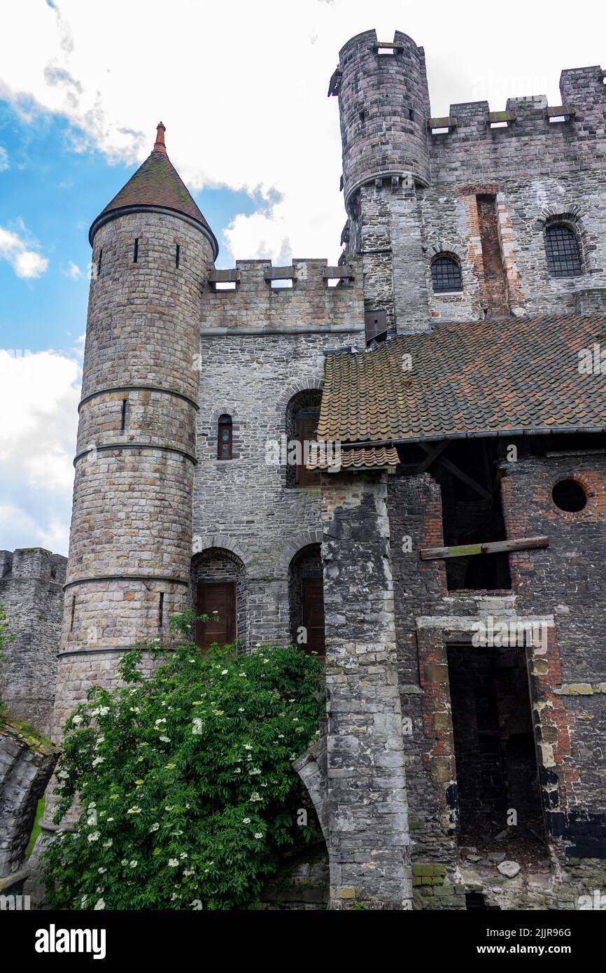 A low angle of the Gravensteen medieval castle in Ghent on a cloudy day ...