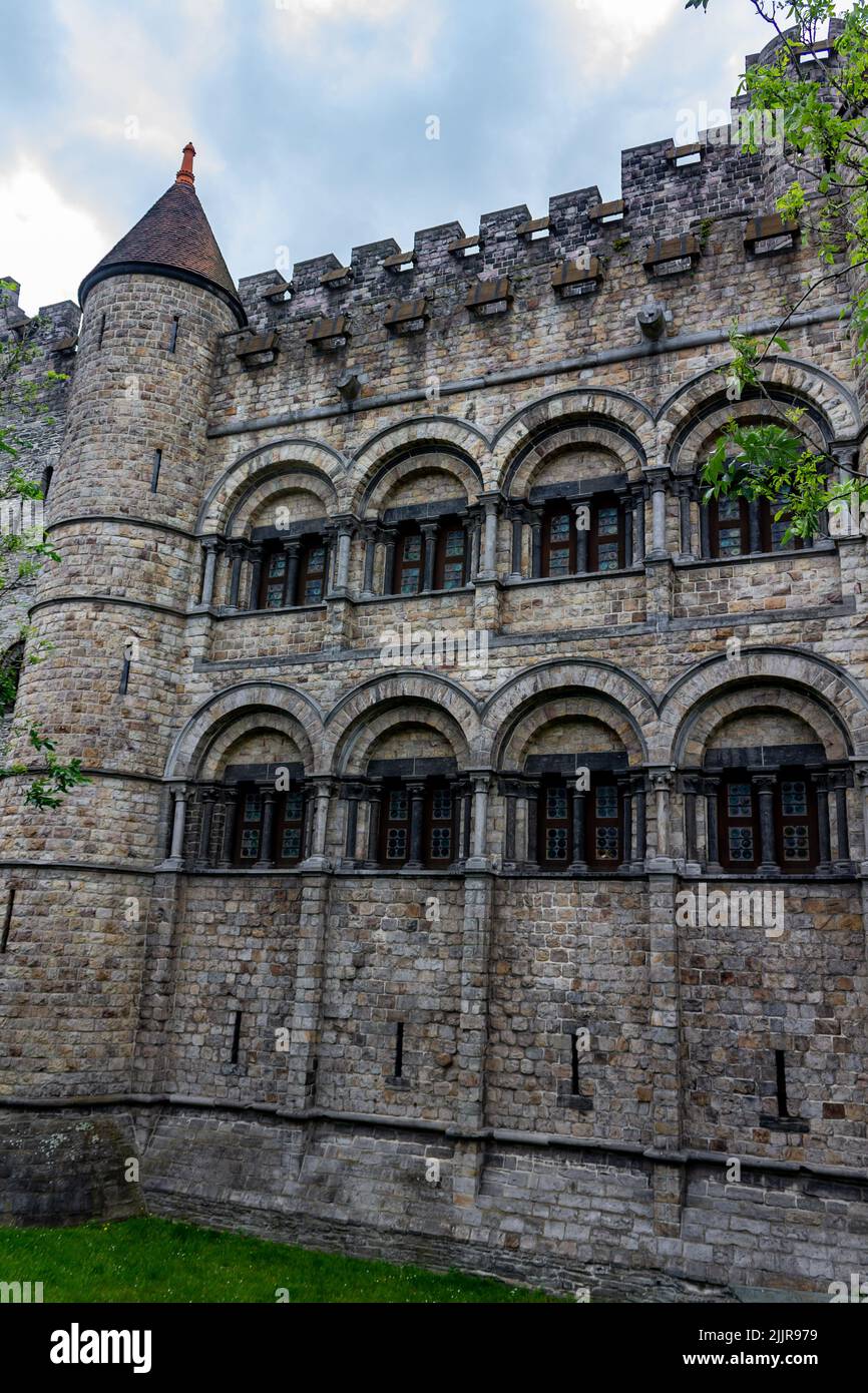 A low angle of the Gravensteen medieval castle in Ghent on a cloudy day ...