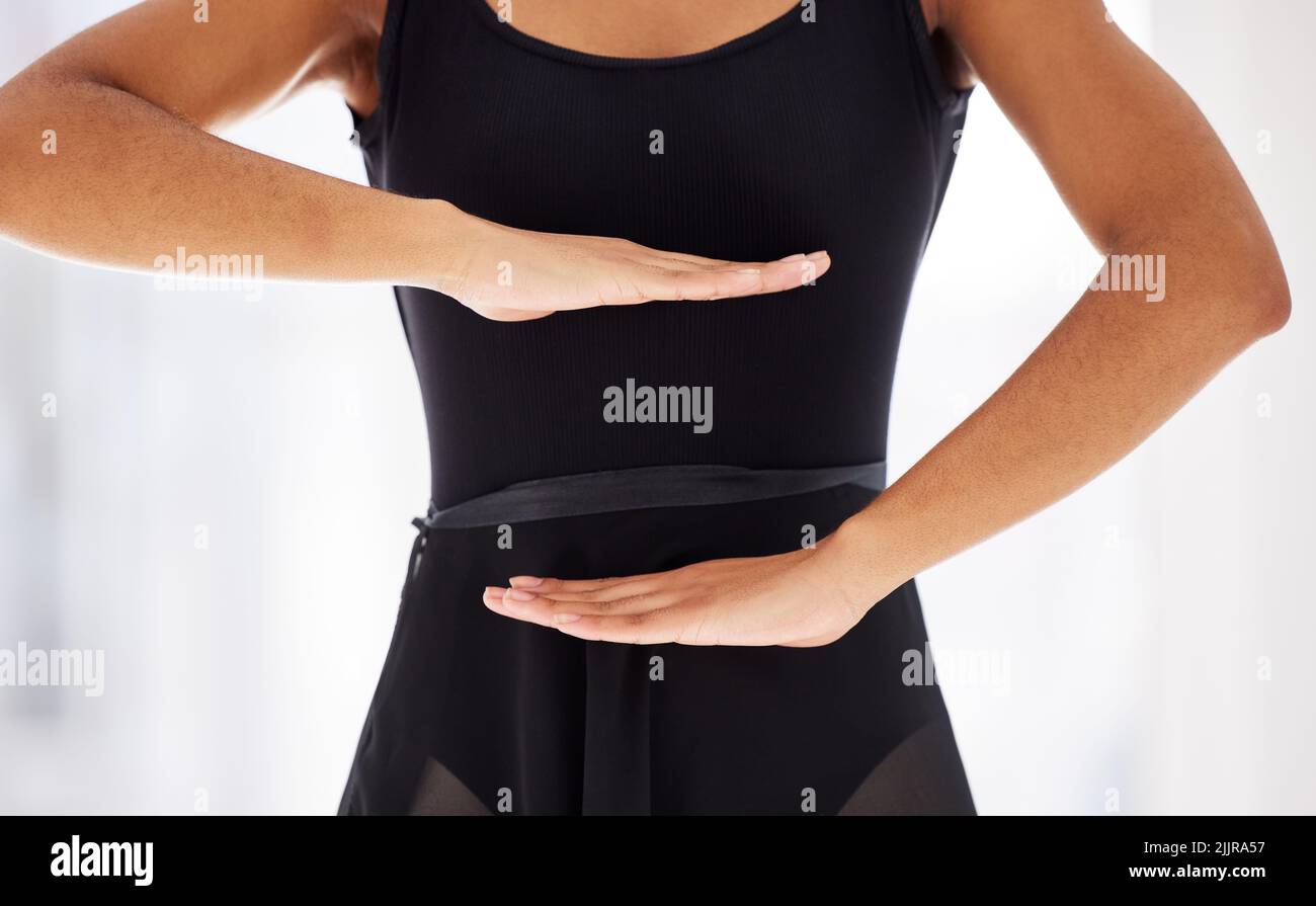 Move from your core. a ballerina holding her hands in front of her stomach Stock Photo - Alamy