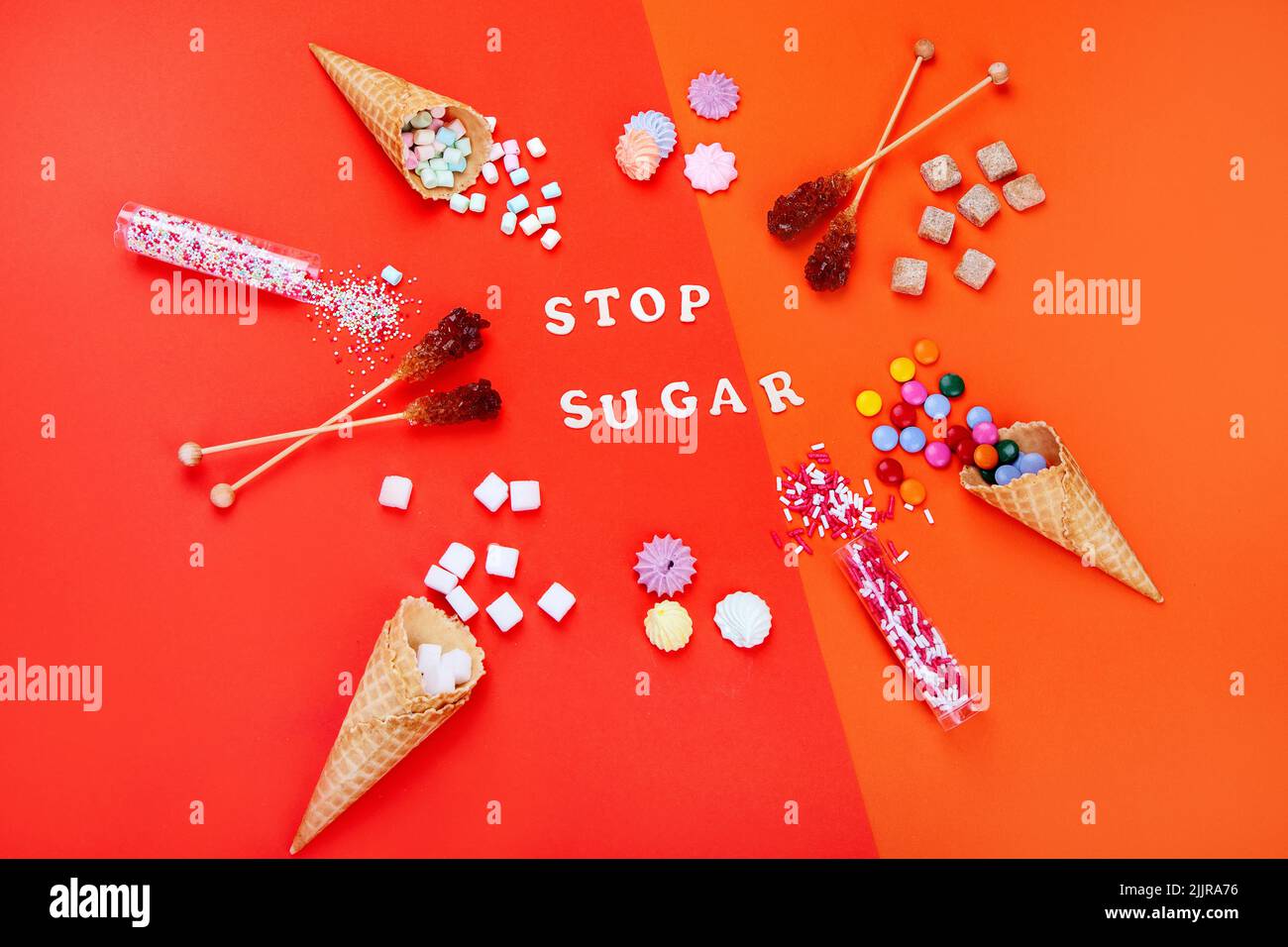 Mix of sweets and candy with sugar spread and written text in unhealthy ...