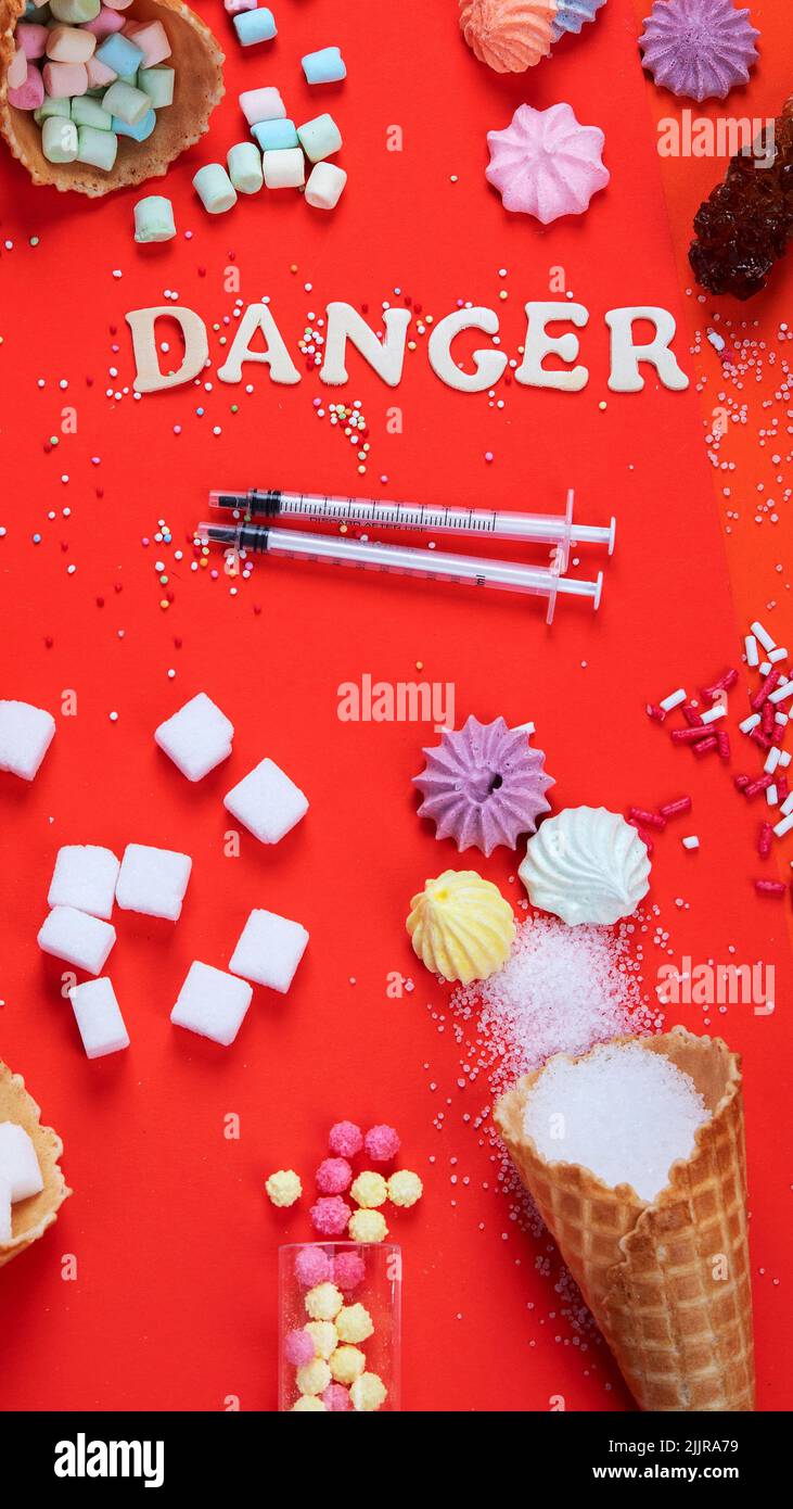 Mix of sweets and candy with sugar spread and written text in unhealthy ...