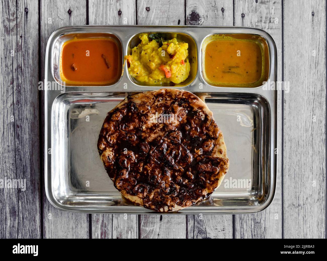 A top view shot of Roti Canai and some sauces on the side Stock Photo ...