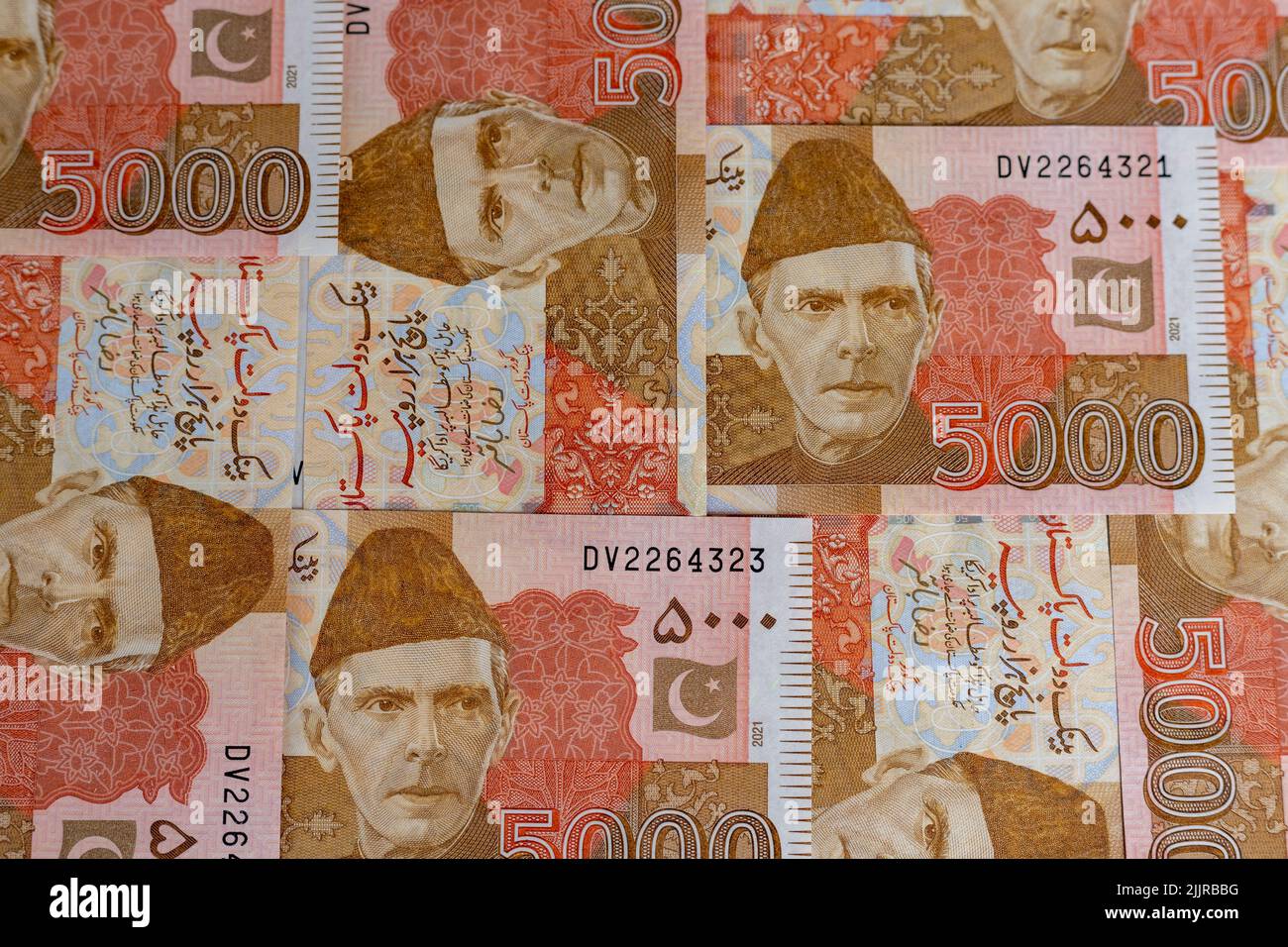Pakistani five thousand rupees banknotes arranged in a pattern texture ...