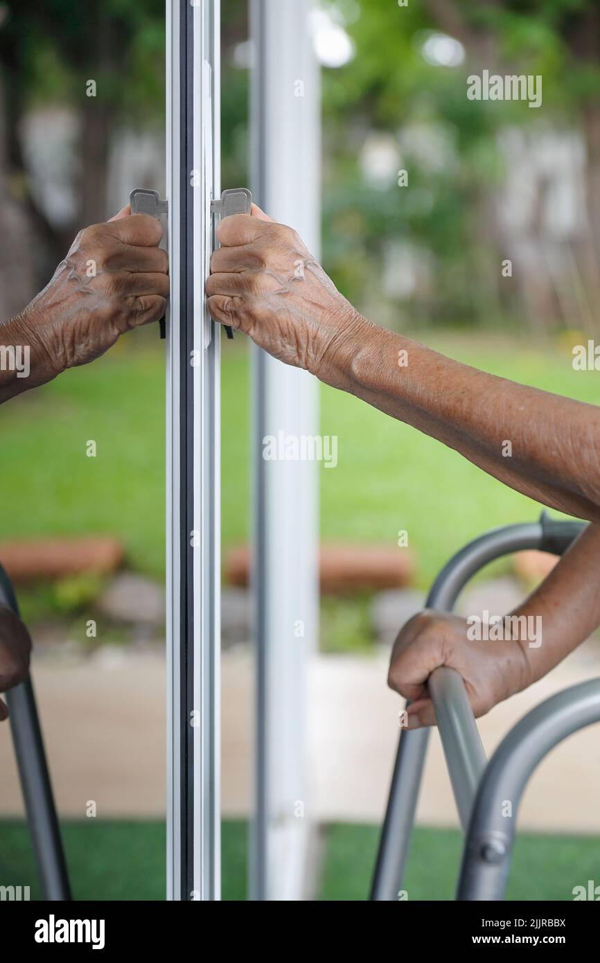 Elderly woman with key opening front door Stock Photo - Alamy