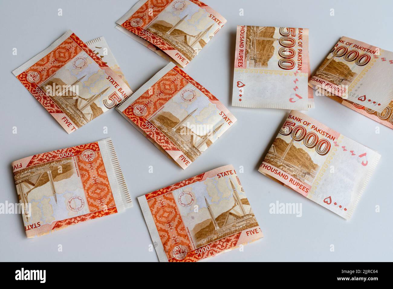 half folded 5000 currency notes on a white isolated background Stock ...