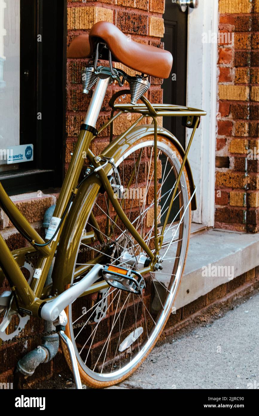 A bicycle with a brown leather seat near a stone building Stock Photo ...