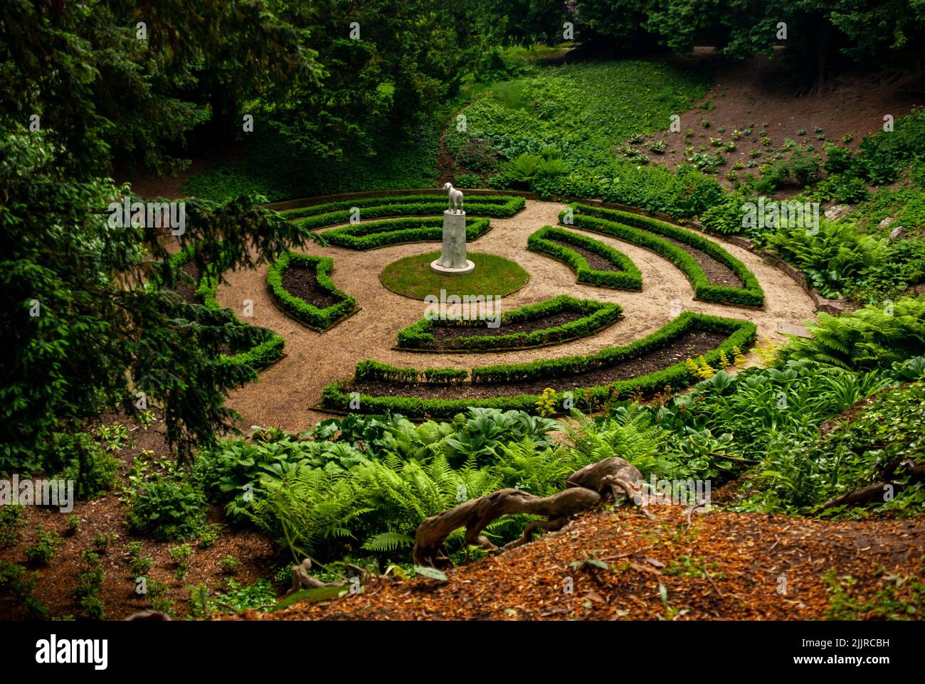 Beautiful urban maze park with statue in the center of it Stock Photo ...