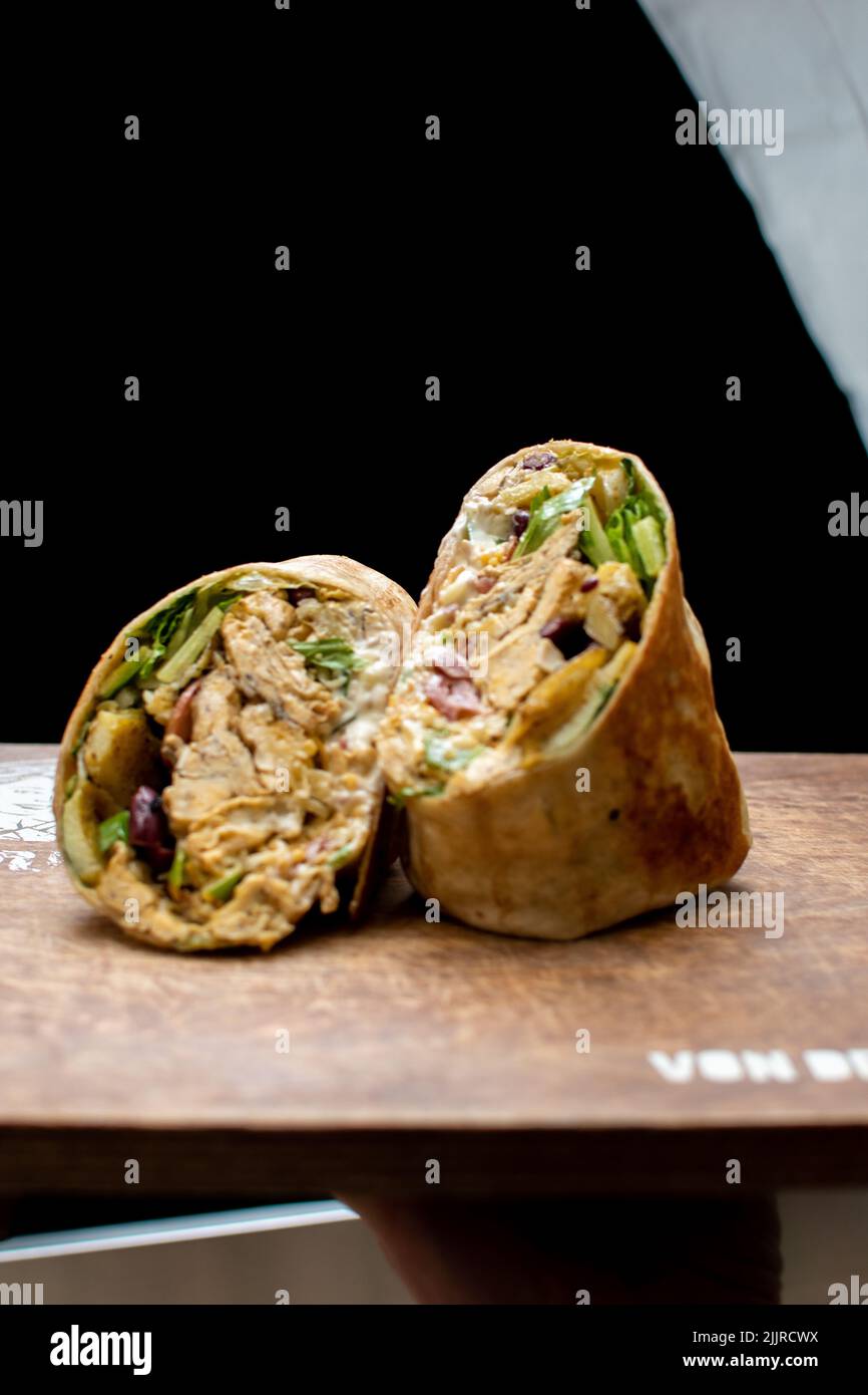 A vertical shot of a cut burrito Stock Photo - Alamy