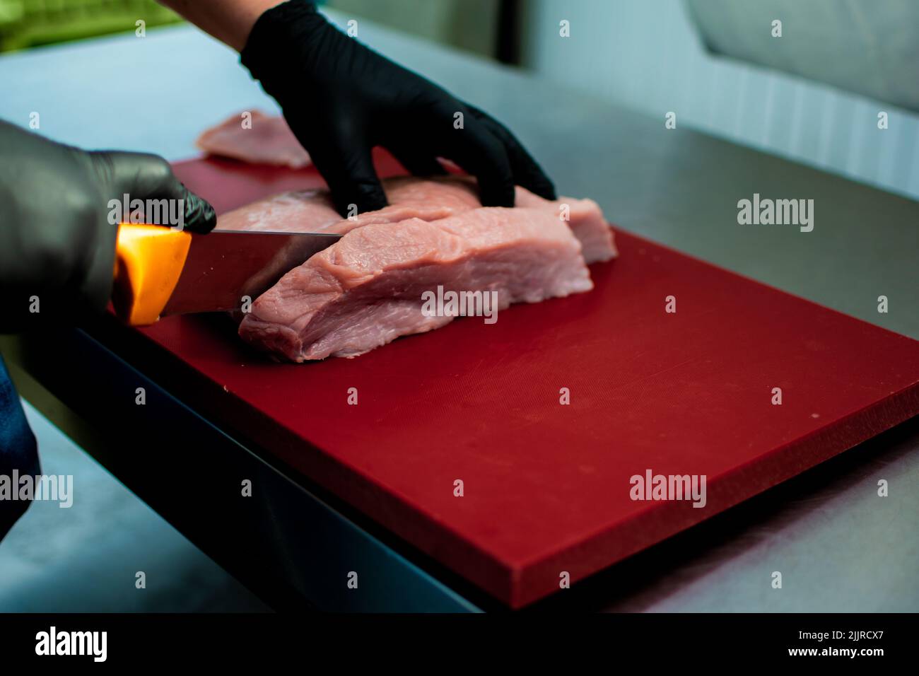 Cutting raw meat hi-res stock photography and images - Alamy