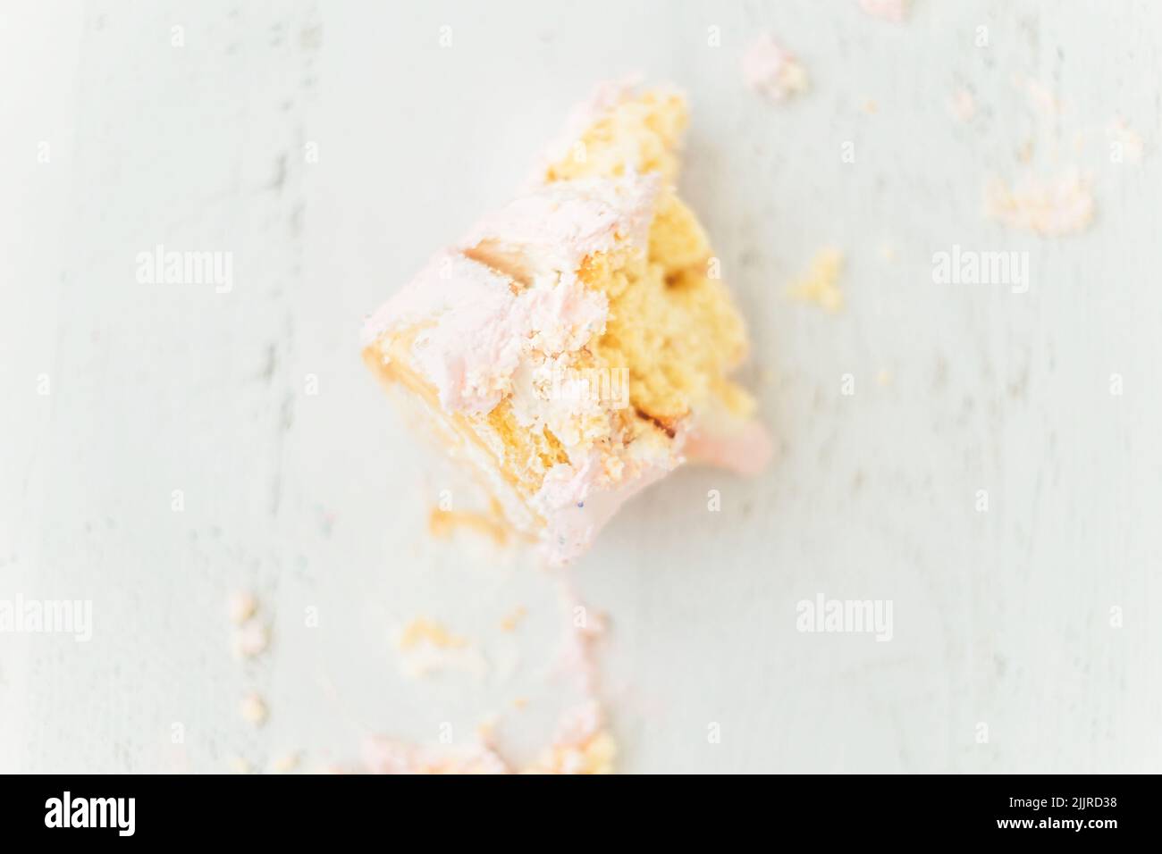A closeup of cake crumbs on white background Stock Photo - Alamy