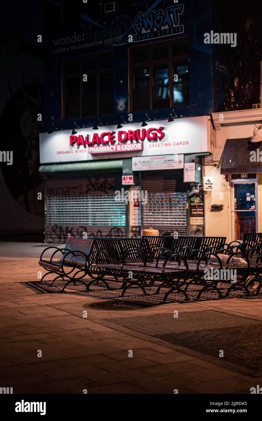 The benches in front of street shops at night Stock Photo - Alamy