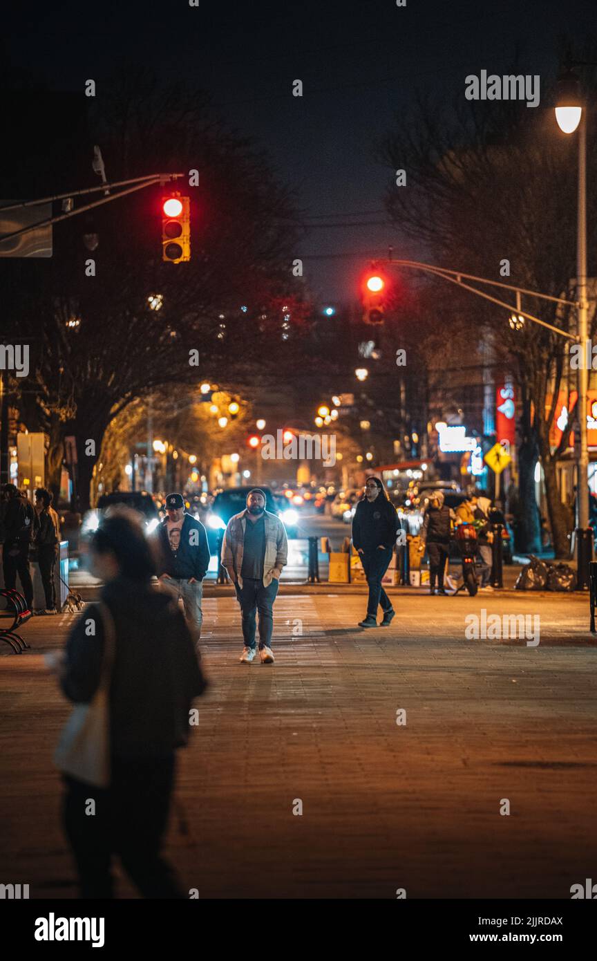 People Walking On The Street At Night