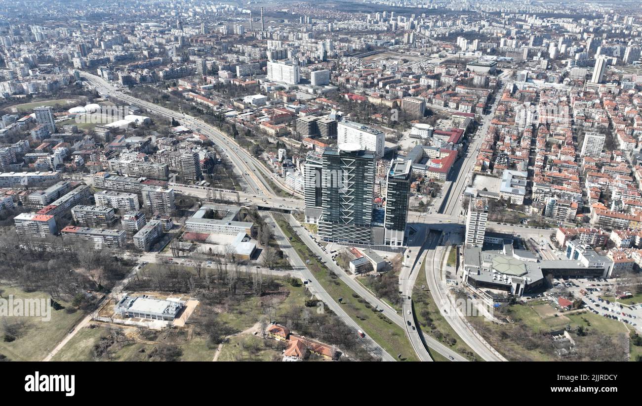 An aerial view of a modern building that stands out from the city of ...