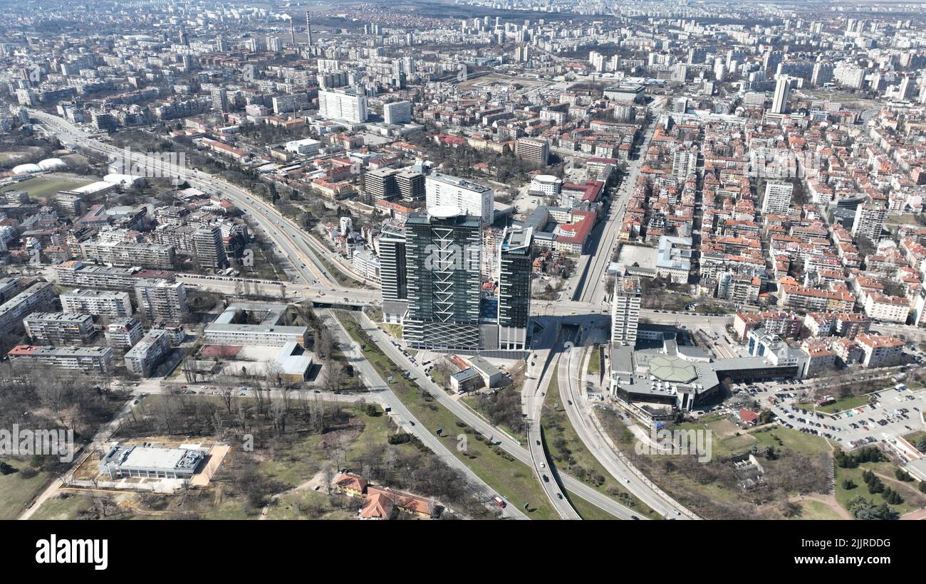 An aerial view of a modern building that stands out from the city of ...