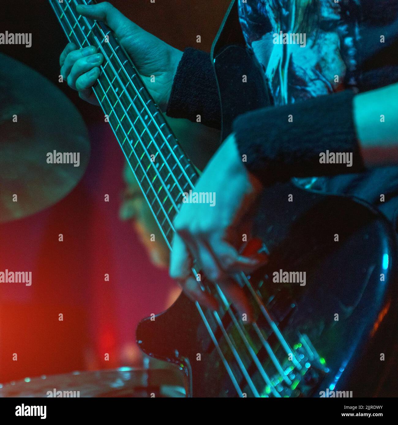 Bass guitarist on stage playing bass guitar close-up. Soft focus Stock ...