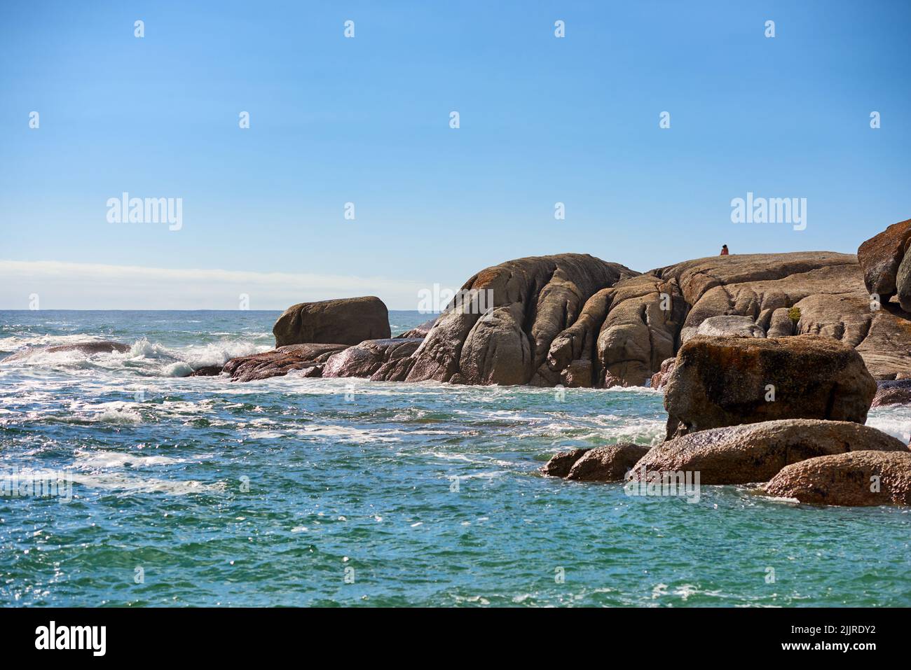Big boulders, rocks and stones at the beach, sea and ocean against a ...