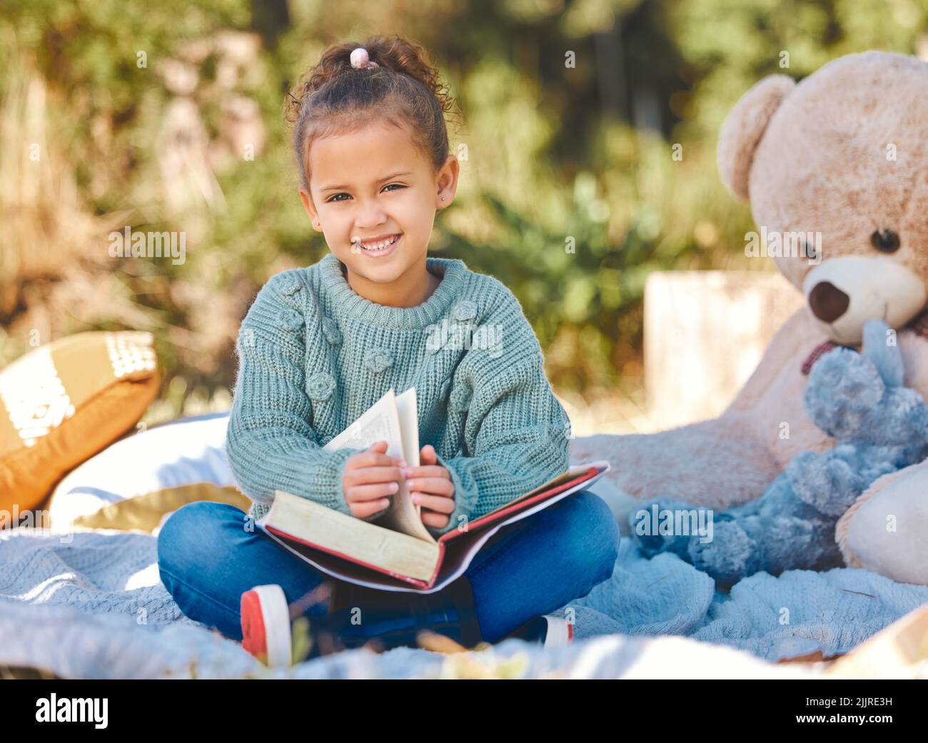 Reading helps develop the mind. a little girl reading a book during a ...