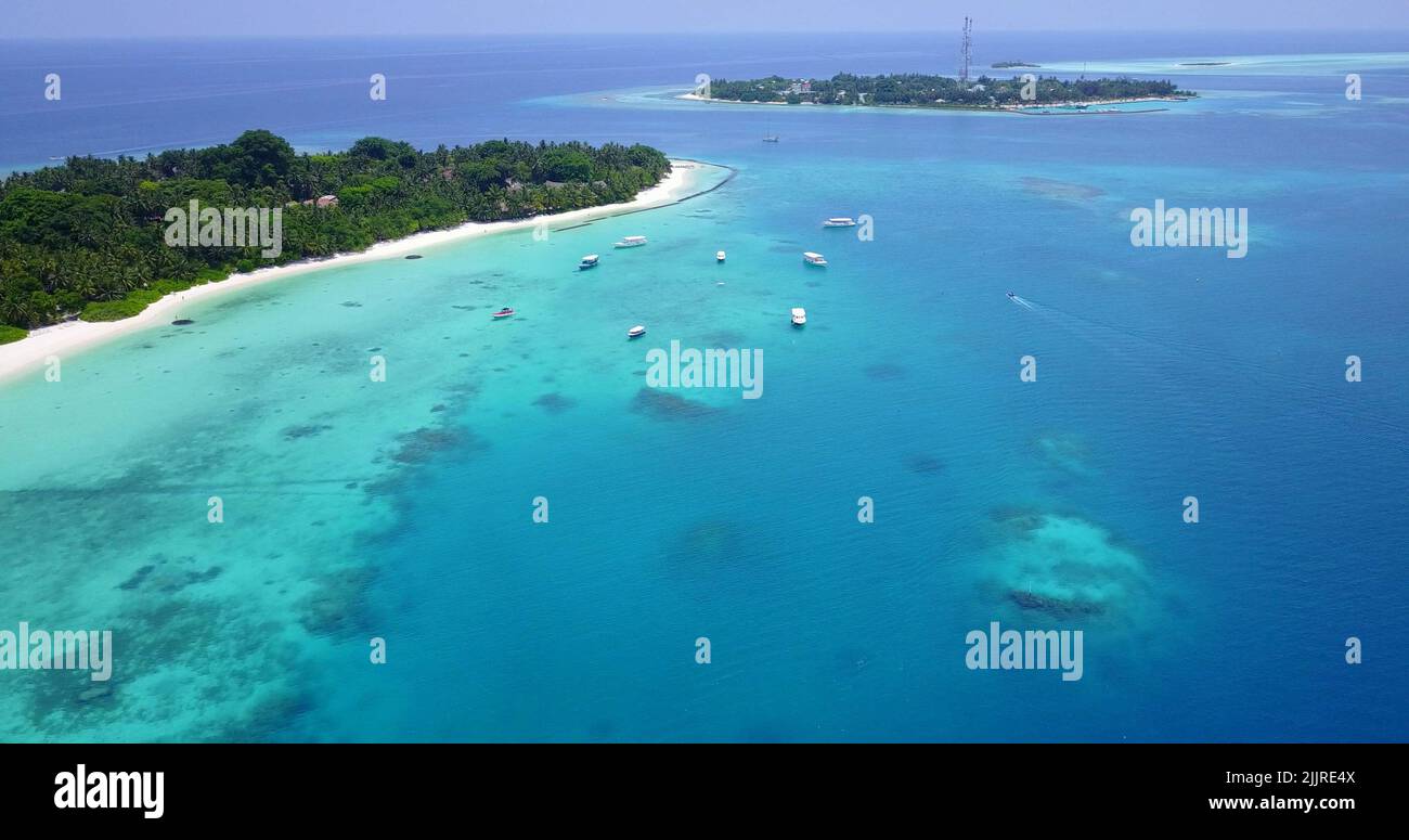 An aerial view of sea surrounded by growing trees in Maldives Stock ...
