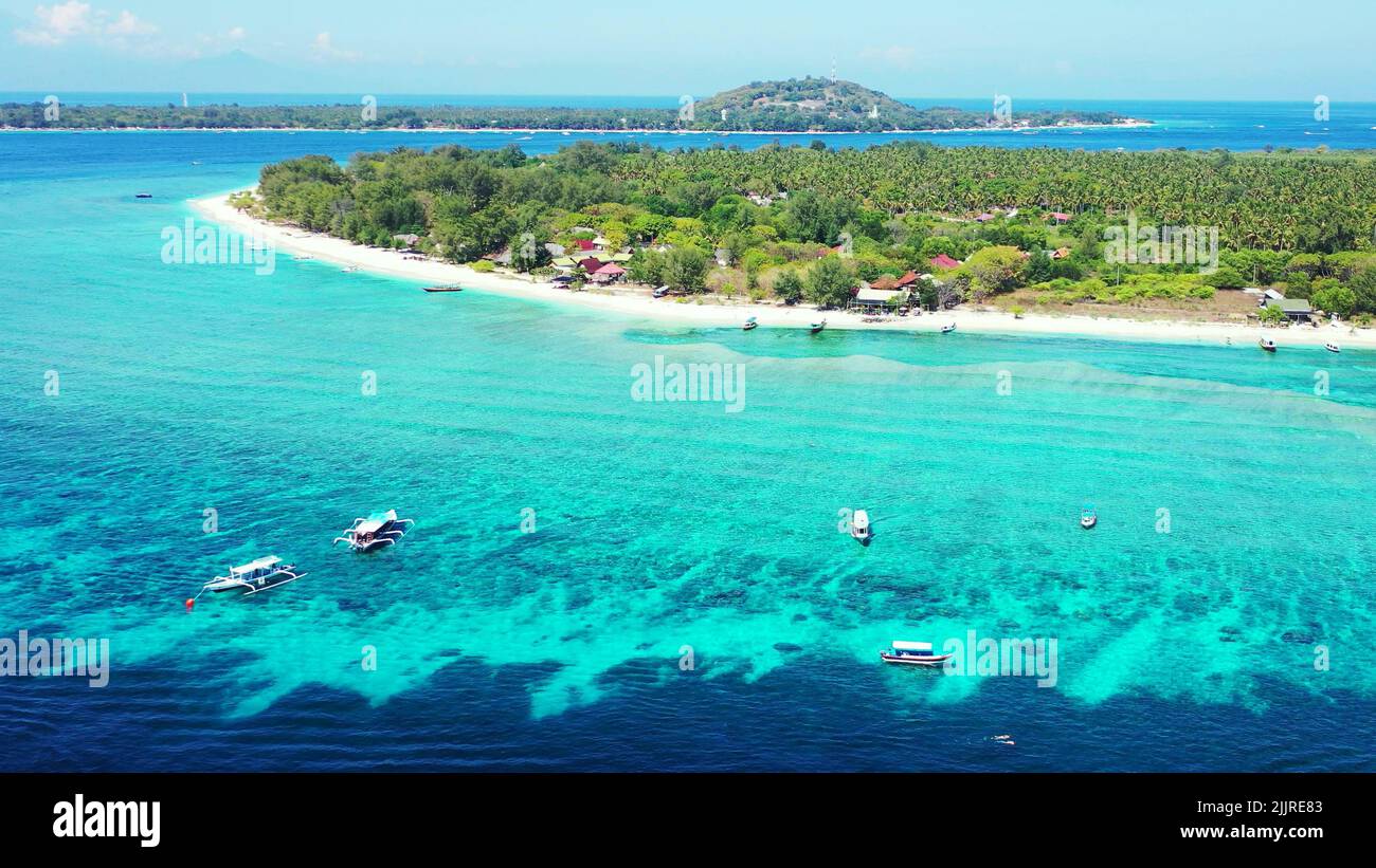 An aerial view of island surrounded by emerald water in Maldives Stock ...