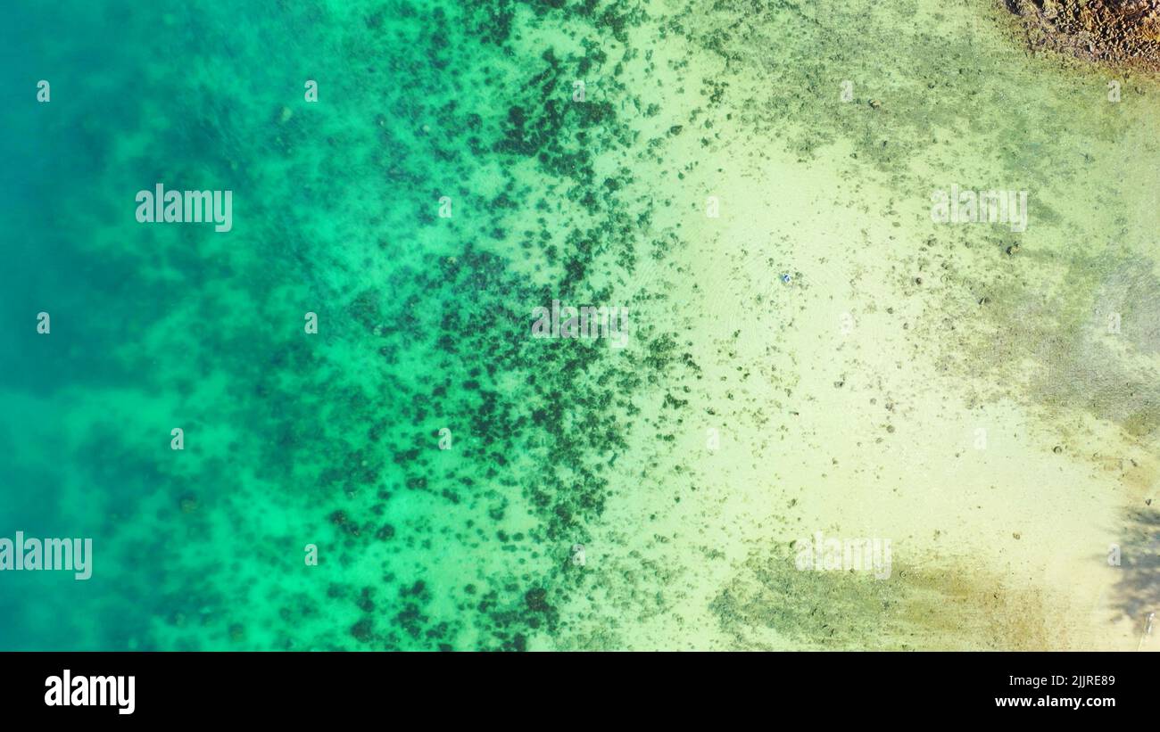 An aerial view of sea surface with green water Stock Photo - Alamy