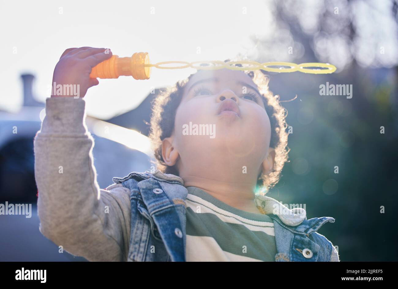 Im trying to blow a big bubble. an adorable little boy blowing bubbles ...