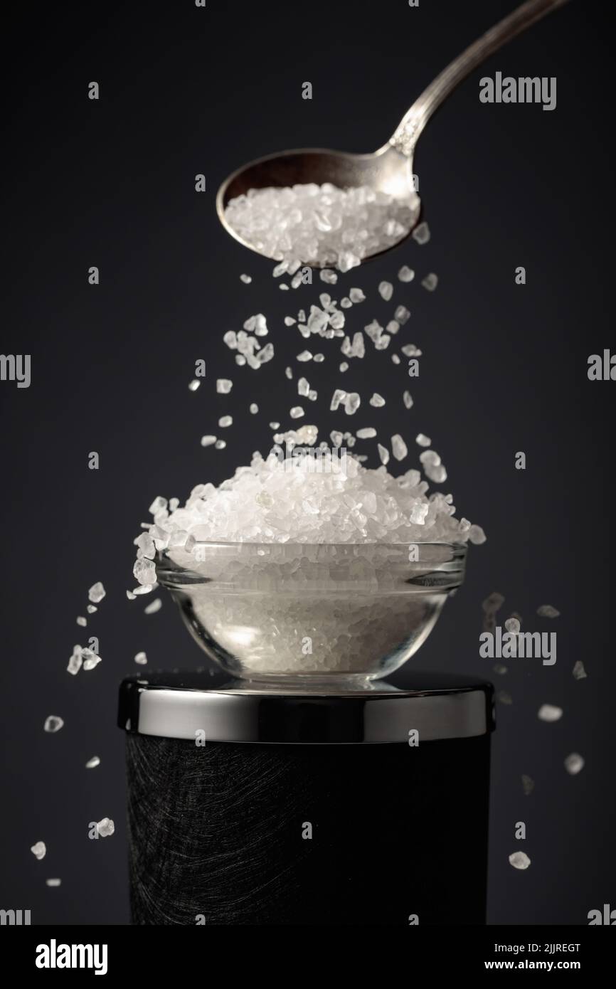 Sea salt is poured into a small glass bowl Stock Photo - Alamy