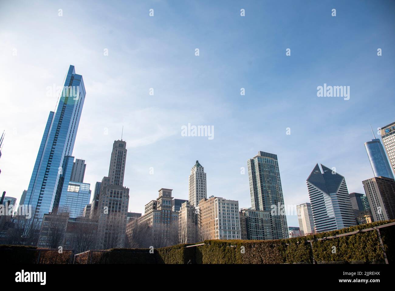 The modern glassy high-rise buildings and skyscrapers against a cloudy ...