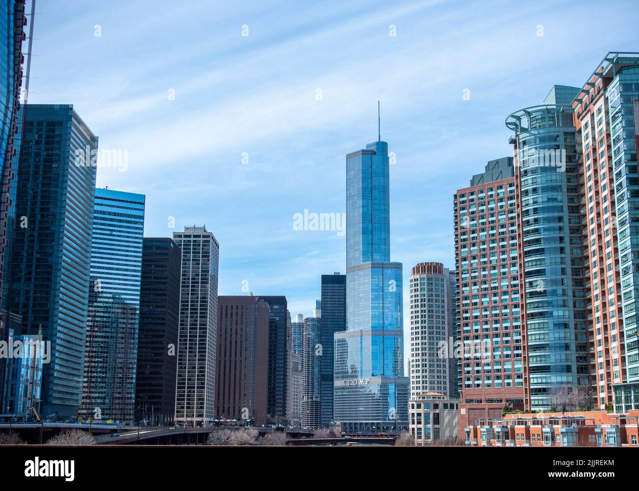 The modern glassy high-rise buildings and skyscrapers against a cloudy ...